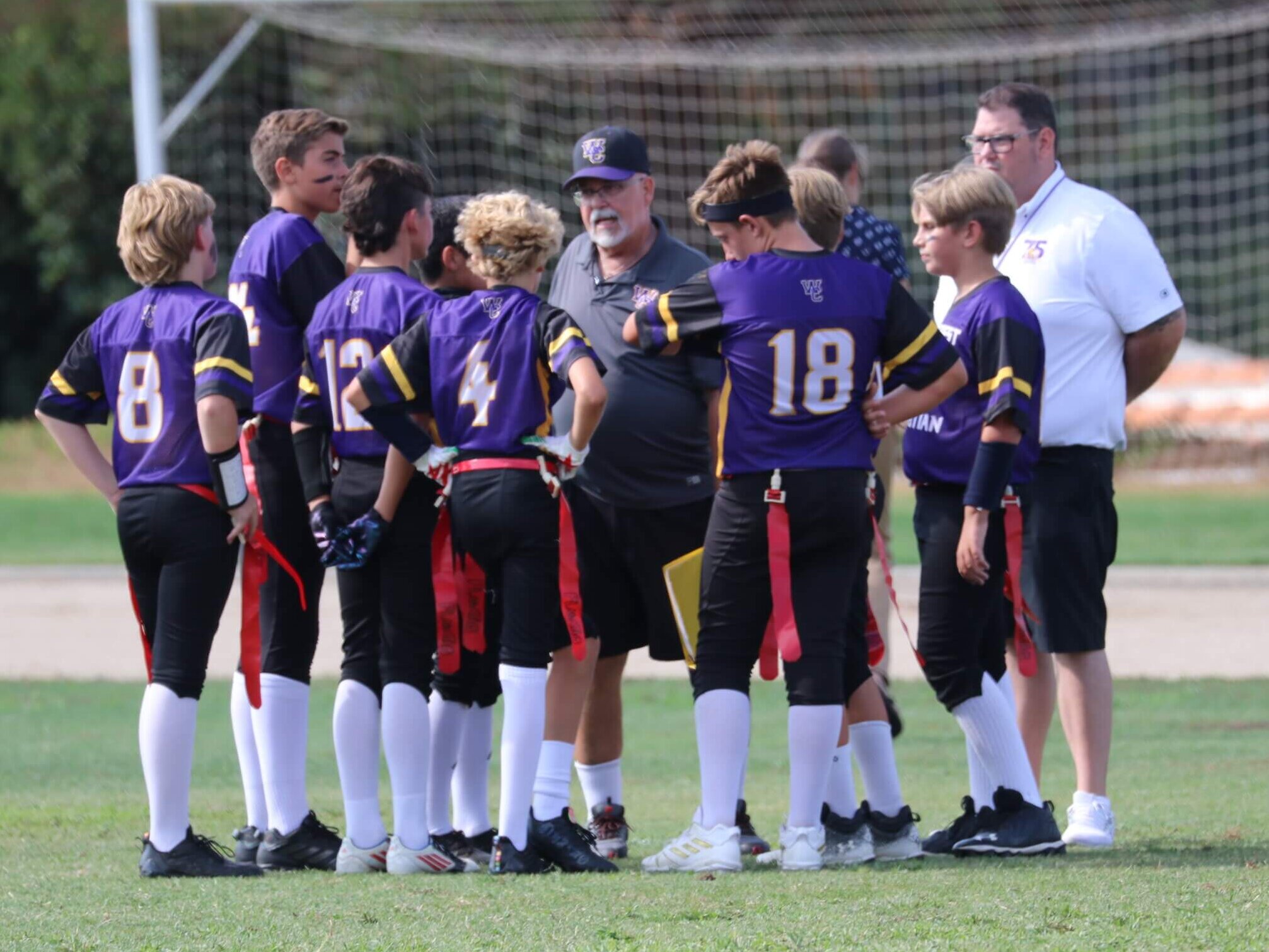 flag football huddleJPG - Woodcrest Christian School System